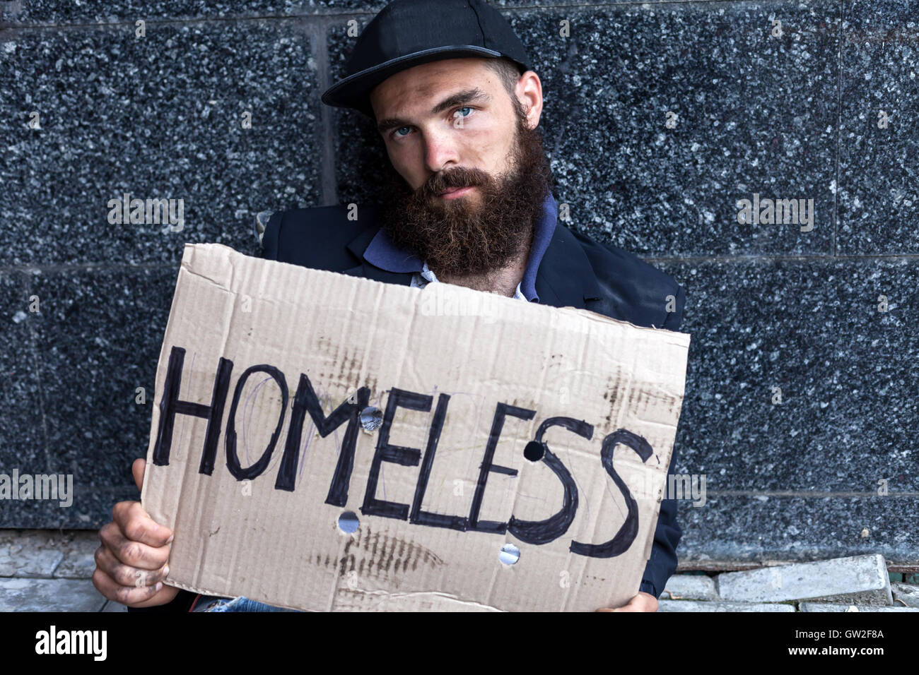 Vagrant with cardboard Stock Photo - Alamy
