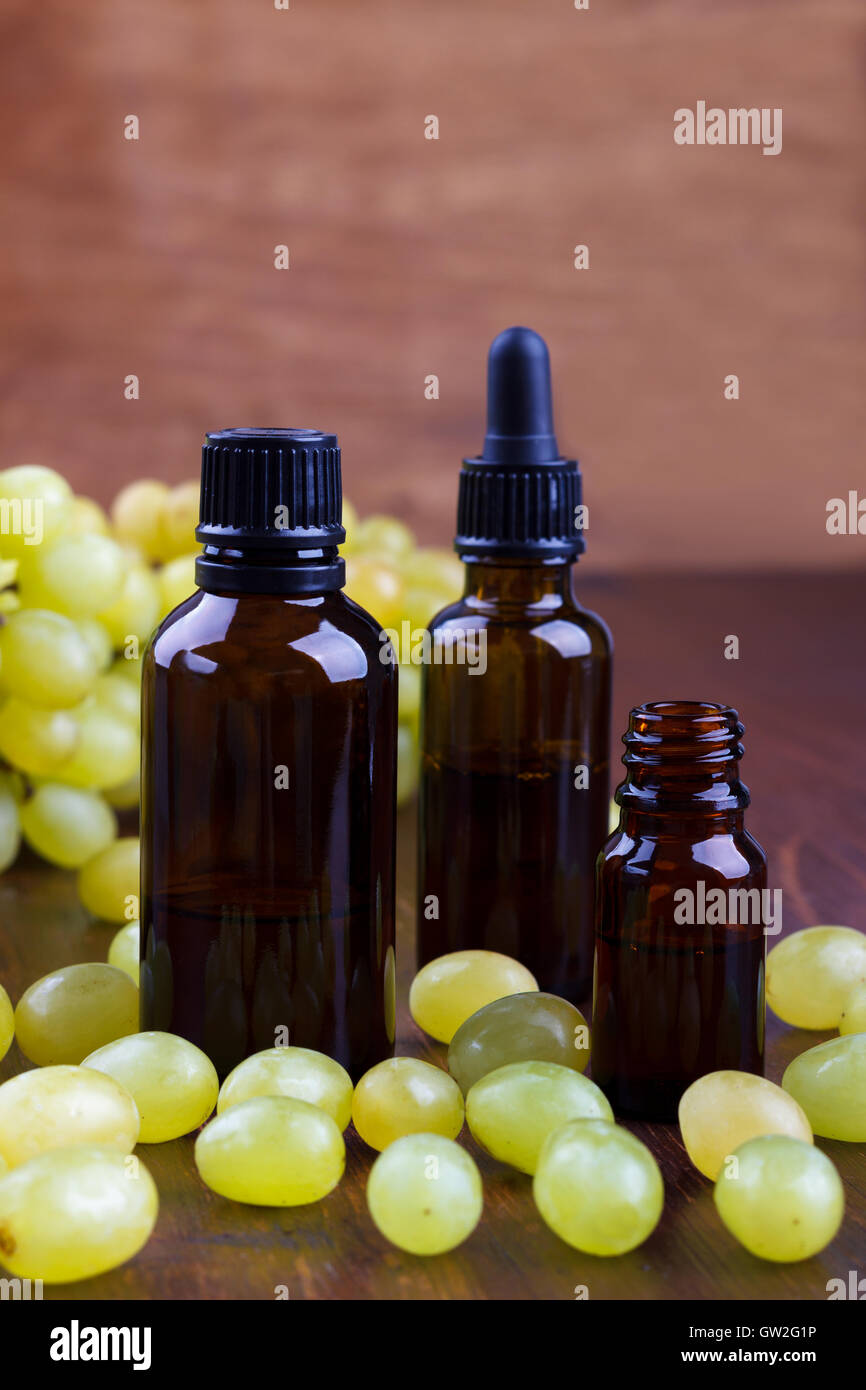 Grape essential oil in small bottle. Beauty treatment Stock Photo - Alamy