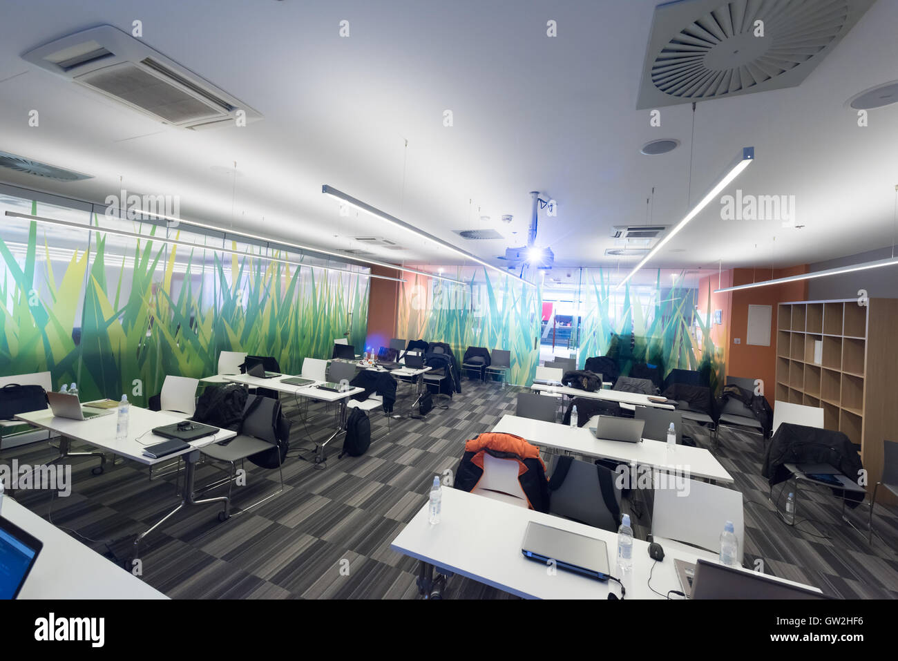 empty it classroom with program code on projector screen and modern ...