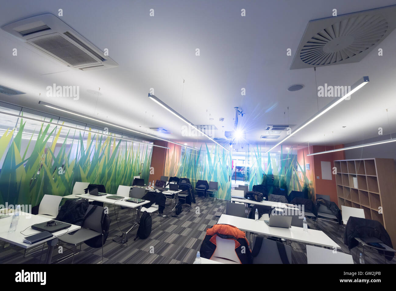 empty it classroom with program code on projector screen and modern ...