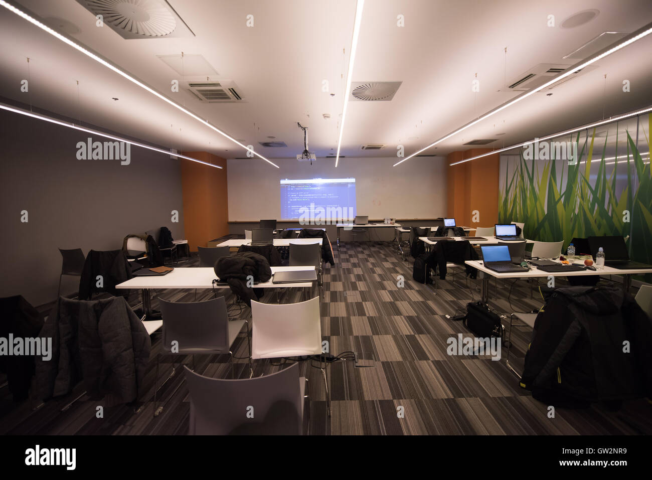 empty it classroom with program code on projector screen and modern ...