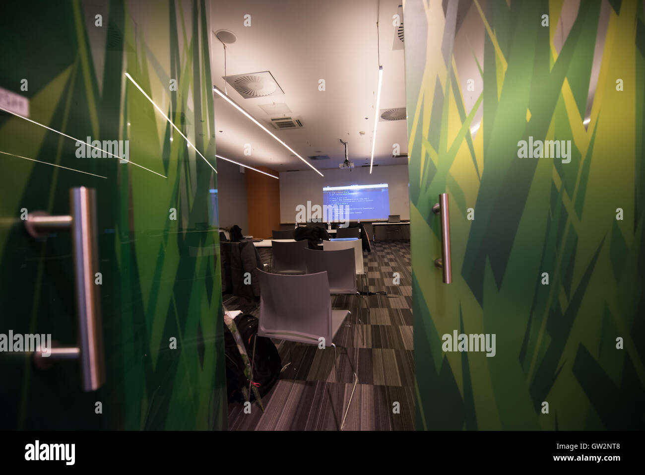 empty it classroom with program code on projector screen and modern ...