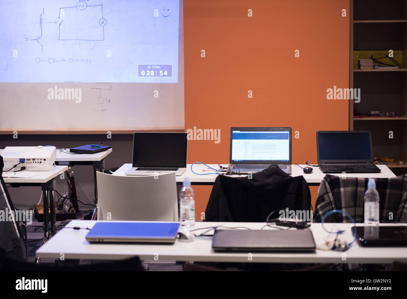 empty it classroom with program code on projector screen and modern ...