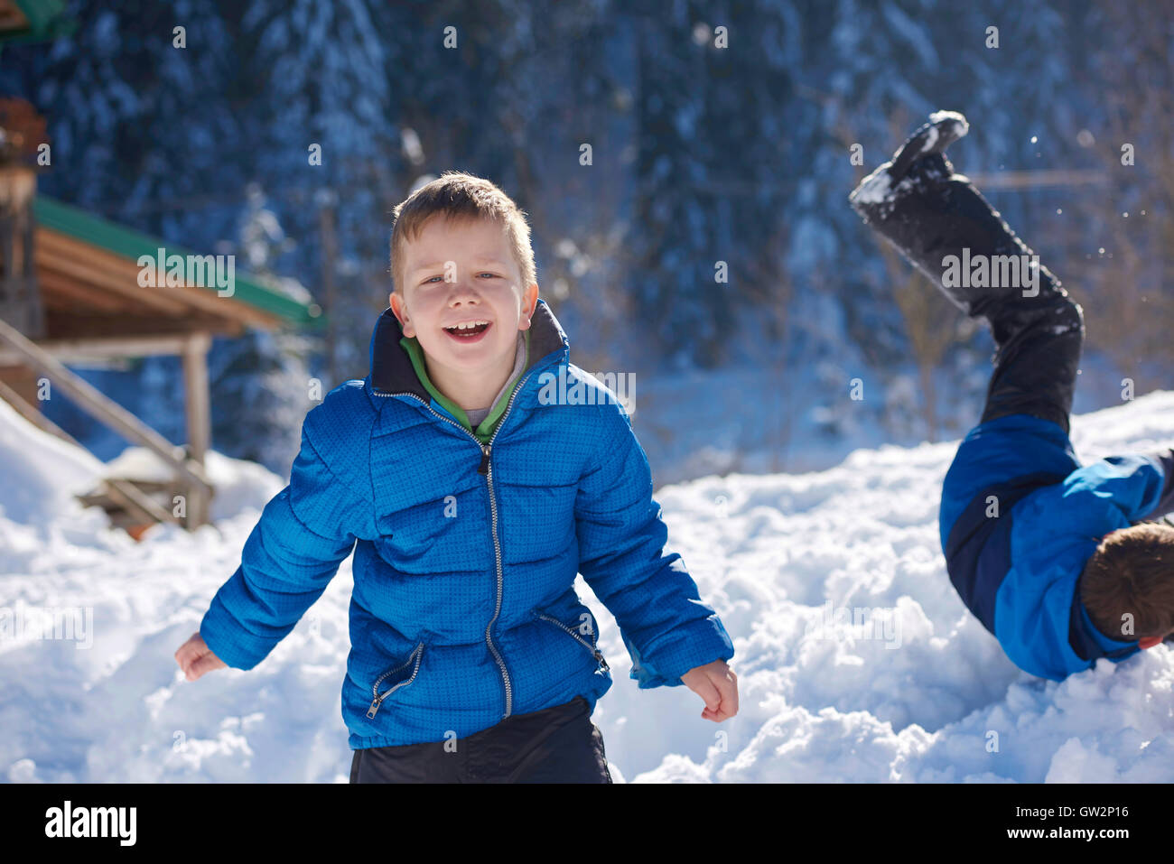 happy kids playing in fresh snow at beautiful sunny winter day Stock ...