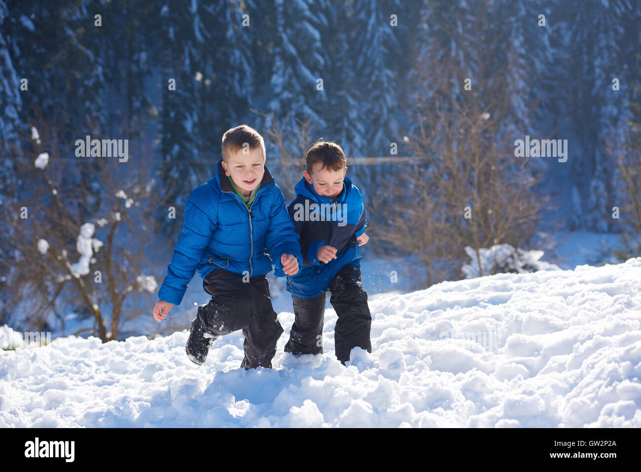 happy kids playing in fresh snow at beautiful sunny winter day Stock ...