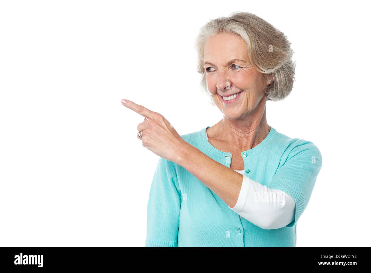 Pretty aged woman pointing at something Stock Photo - Alamy