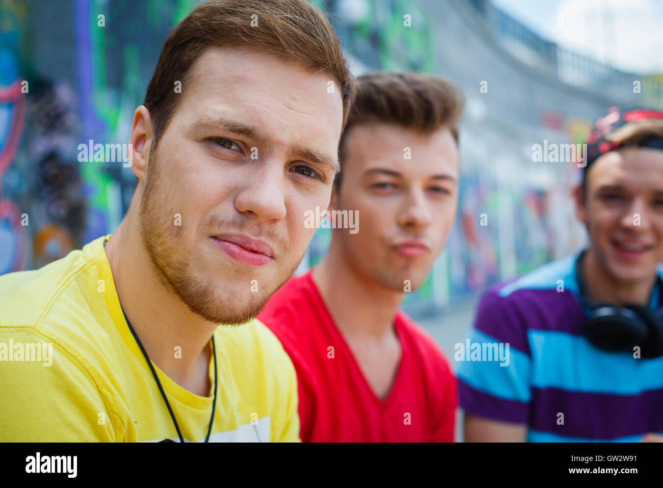 Three young friends happy Stock Photo - Alamy
