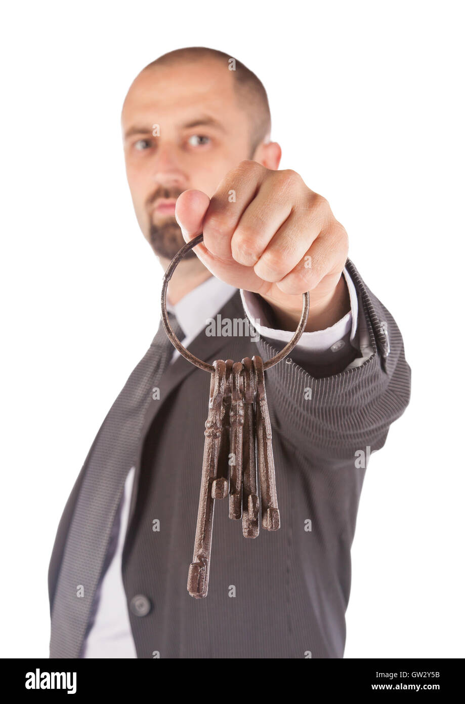 Man in suit giving old keys to a house Stock Photo - Alamy