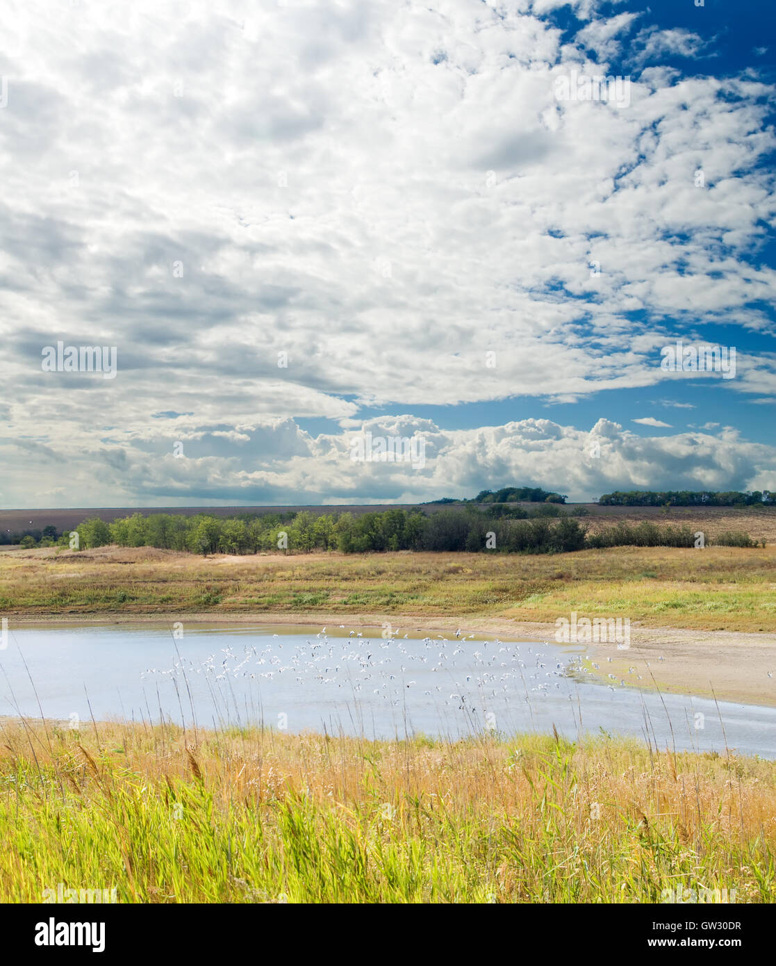cloudy landscape with river Stock Photo - Alamy