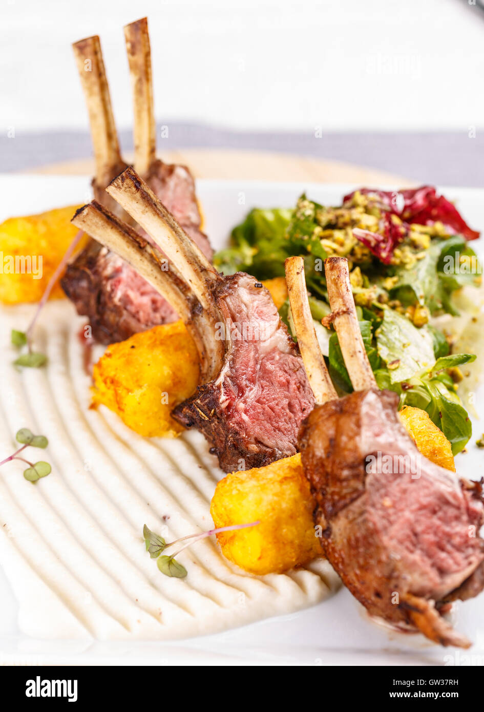 Roasted lamb ribs with mashed potato-filled croquettes Stock Photo - Alamy