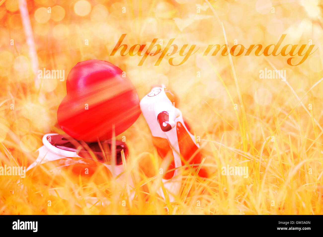 Happy Monday message with a miniature motorcycle carrying a heart ...