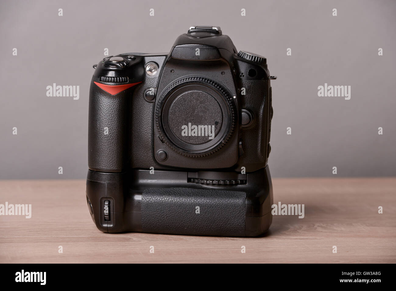 Digital photo camera on wooden desk table Stock Photo - Alamy