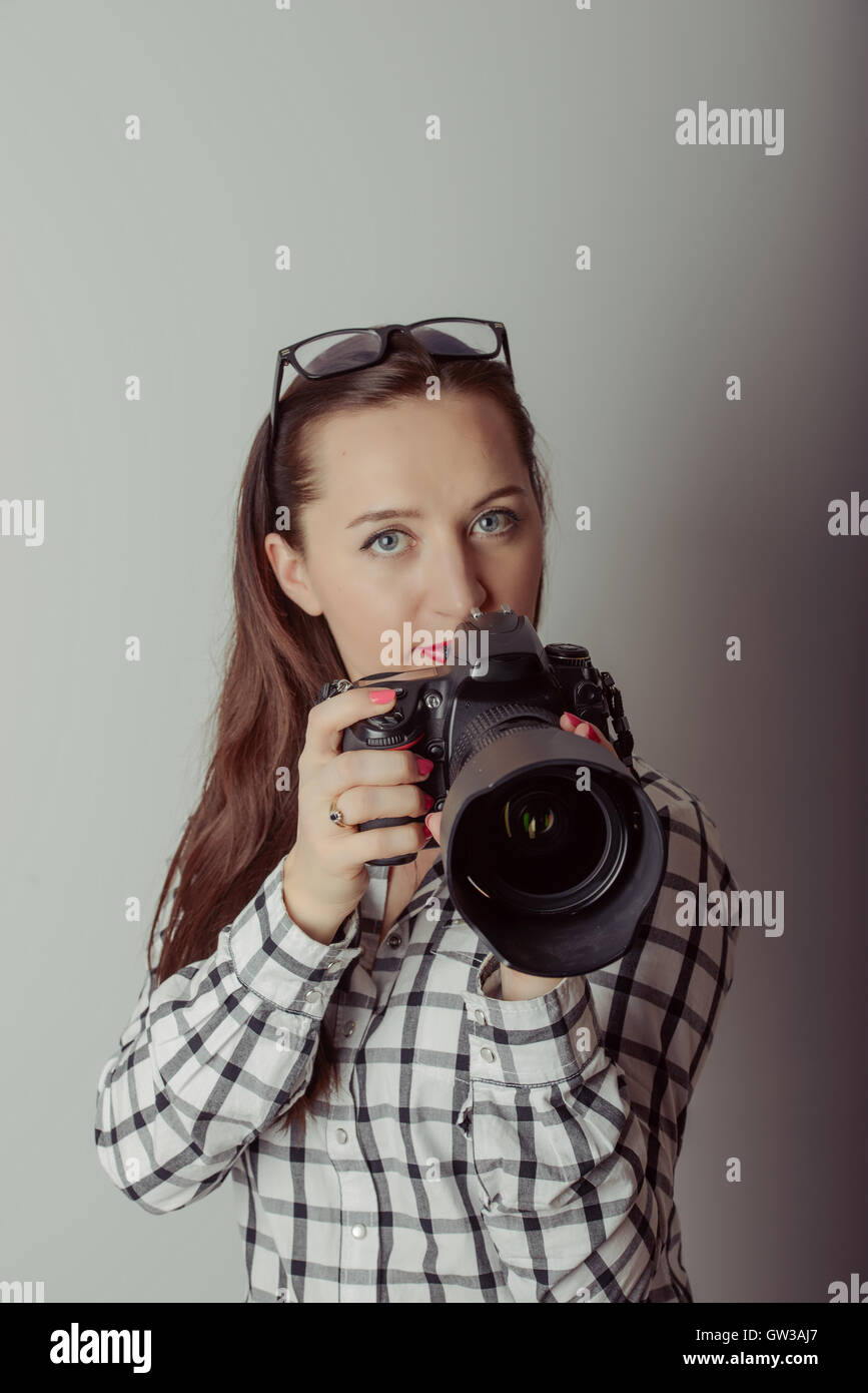 Woman-photographer takes images, isolated on gray background Stock ... Woman-photographer takes images, isolated on gray background Stock ...