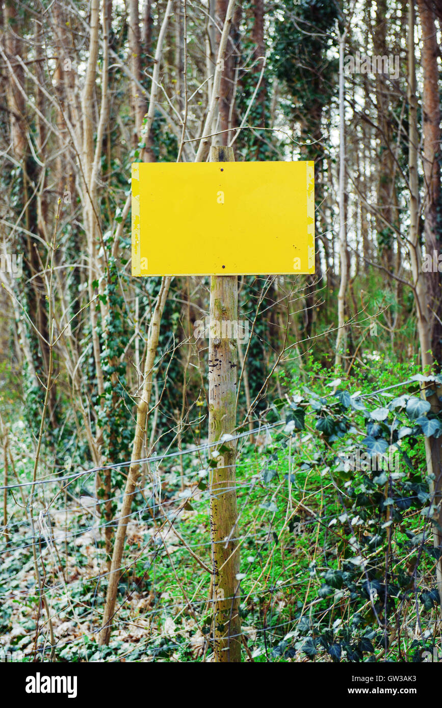 Warning Sign on a forest behind the fence Stock Photo - Alamy