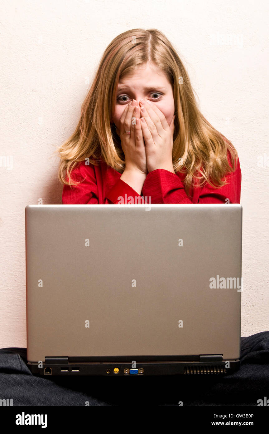 tween girl making a shocked expression in front of her laptop Stock ...