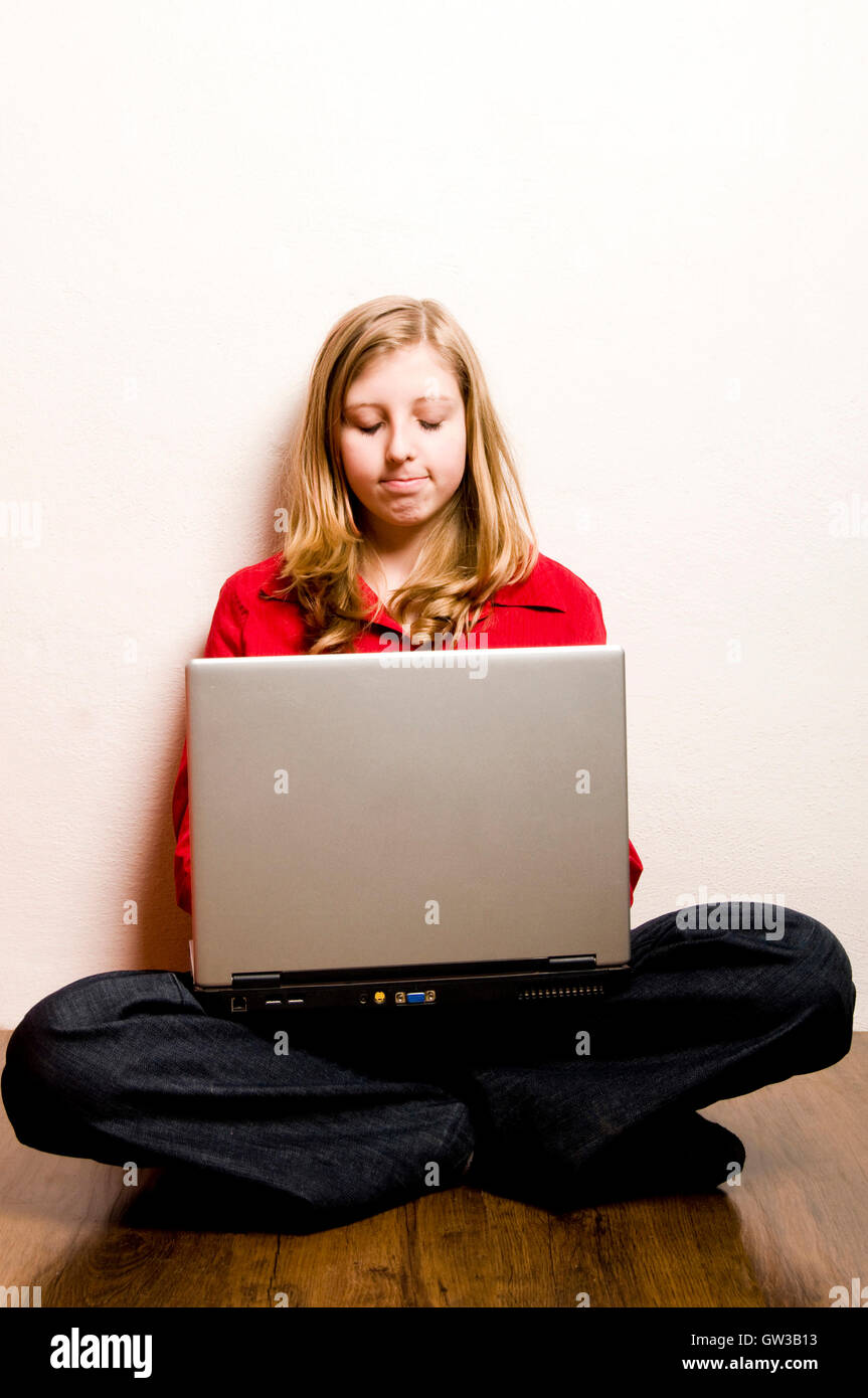 tween girl making a disappointed expression in front of her laptop ...