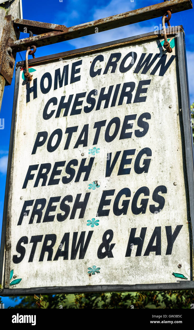 A rustic sign outside a farm selling various produce Stock Photo - Alamy
