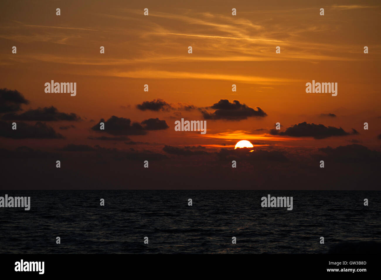 Beautiful sunset in the sea with clouds, italy Stock Photo - Alamy