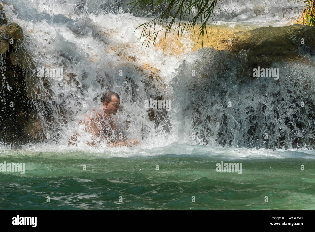 Refreshing, man enjoying the Kuang Xi falls, southwest of Luang Prabang ...