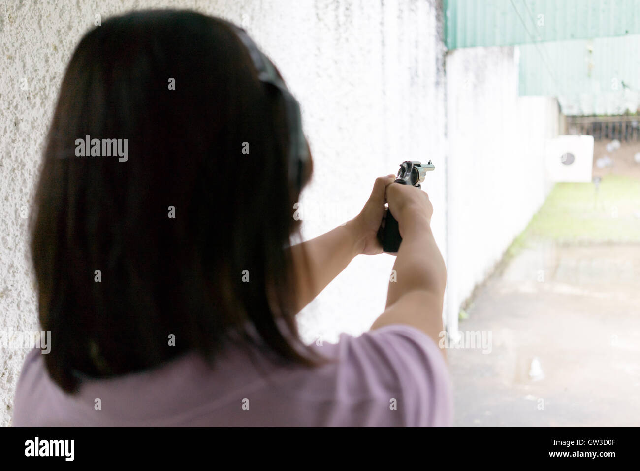 Woman with gun target hi-res stock photography and images - Alamy