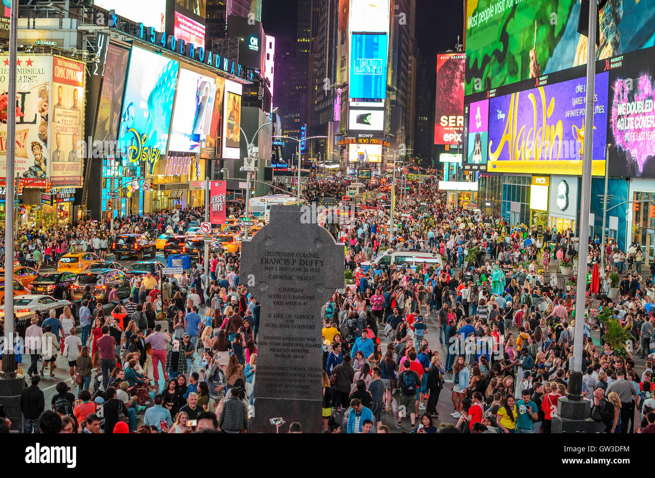 Times Square crowds at night in Midtown Manhattan. The site is regarded ...