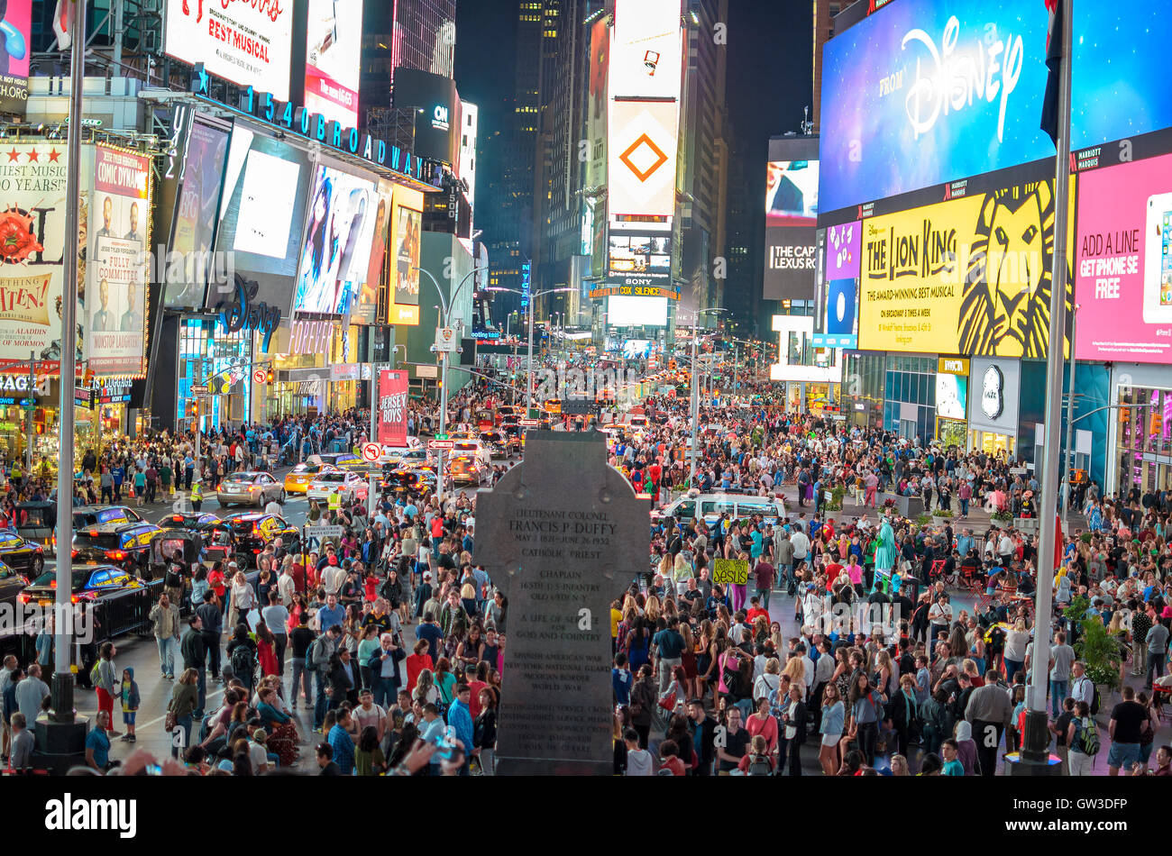 Times Square crowds at night in Midtown Manhattan. The site is regarded ...
