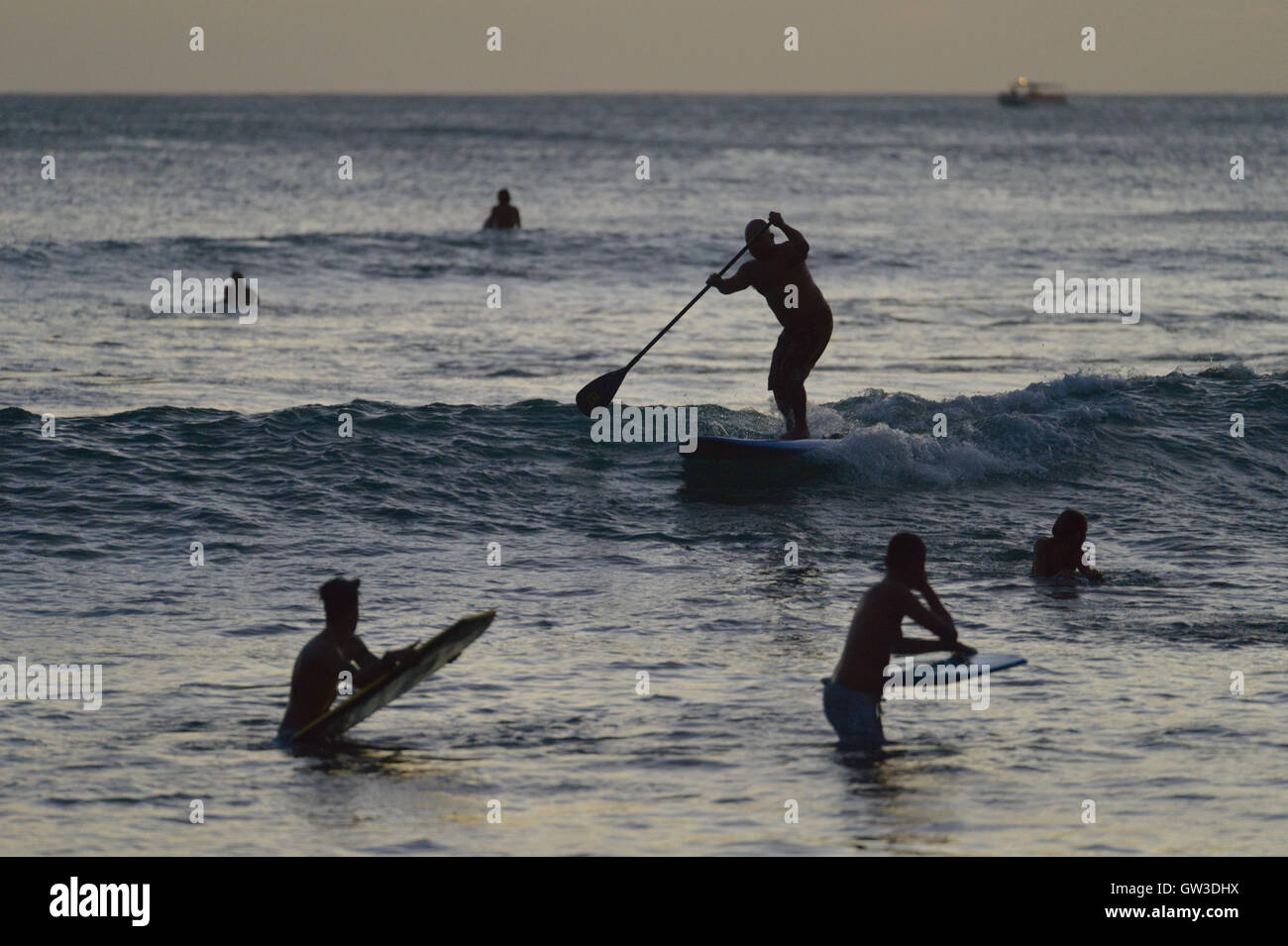 Water activities during sunset at Waikiki beach, Honolulu HI Stock ...