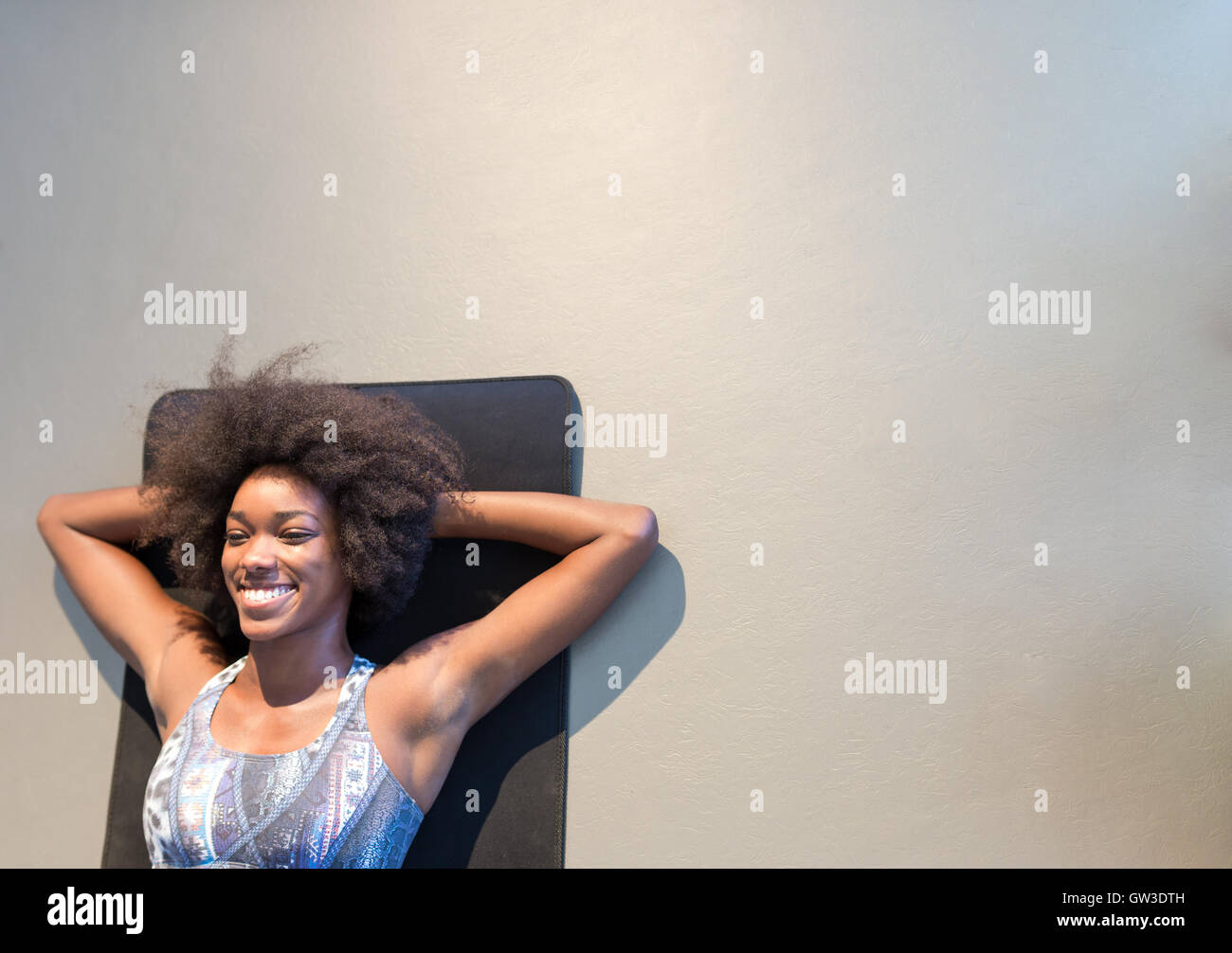 Young African American woman with a wild frizzy afro hairstyle smiling ...