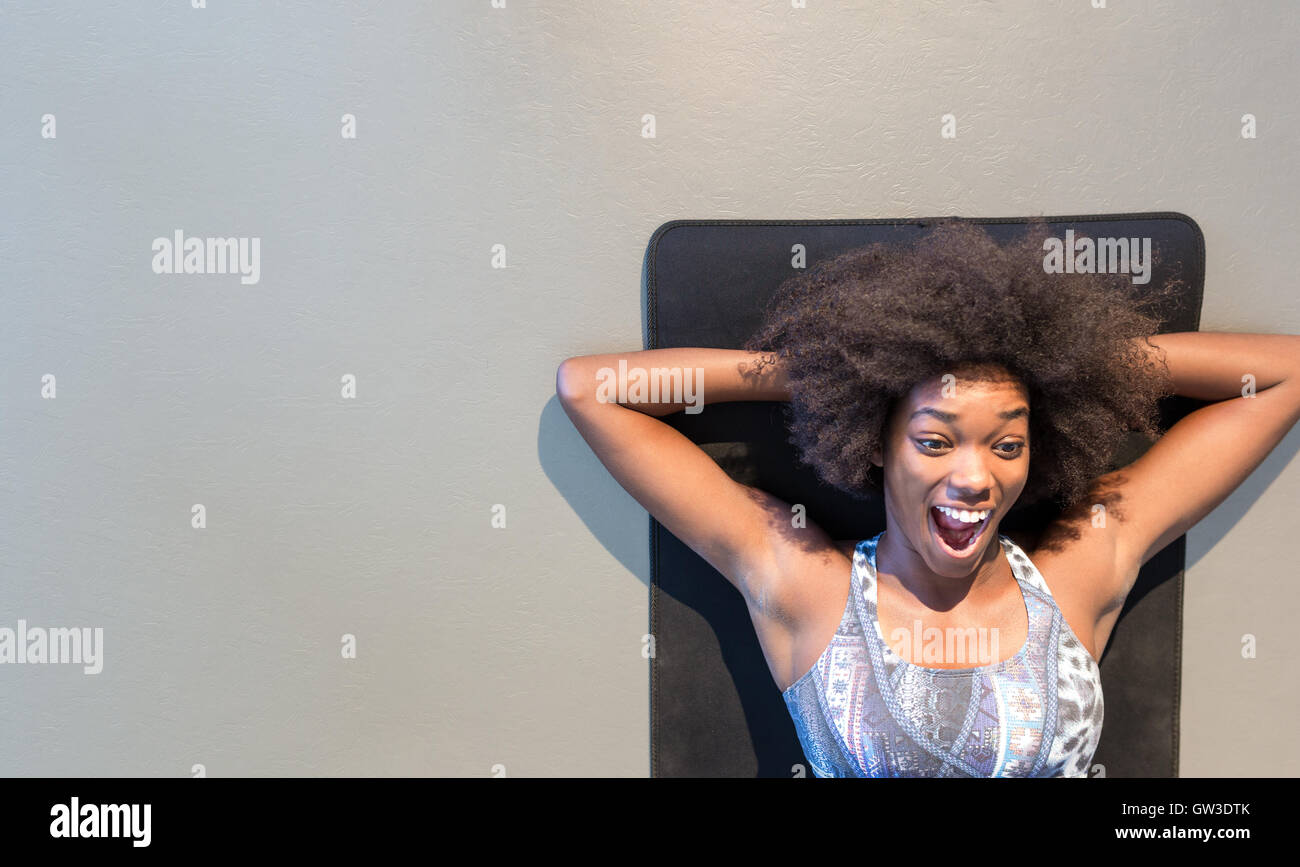 Young African American woman with a wild frizzy afro hairstyle smiling ...