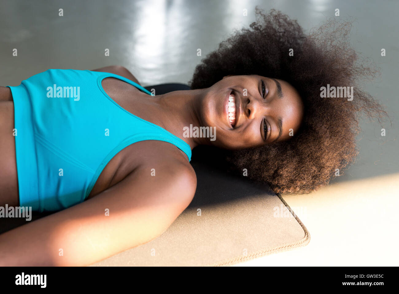 Young African American woman with a wild frizzy afro hairstyle smiling ...