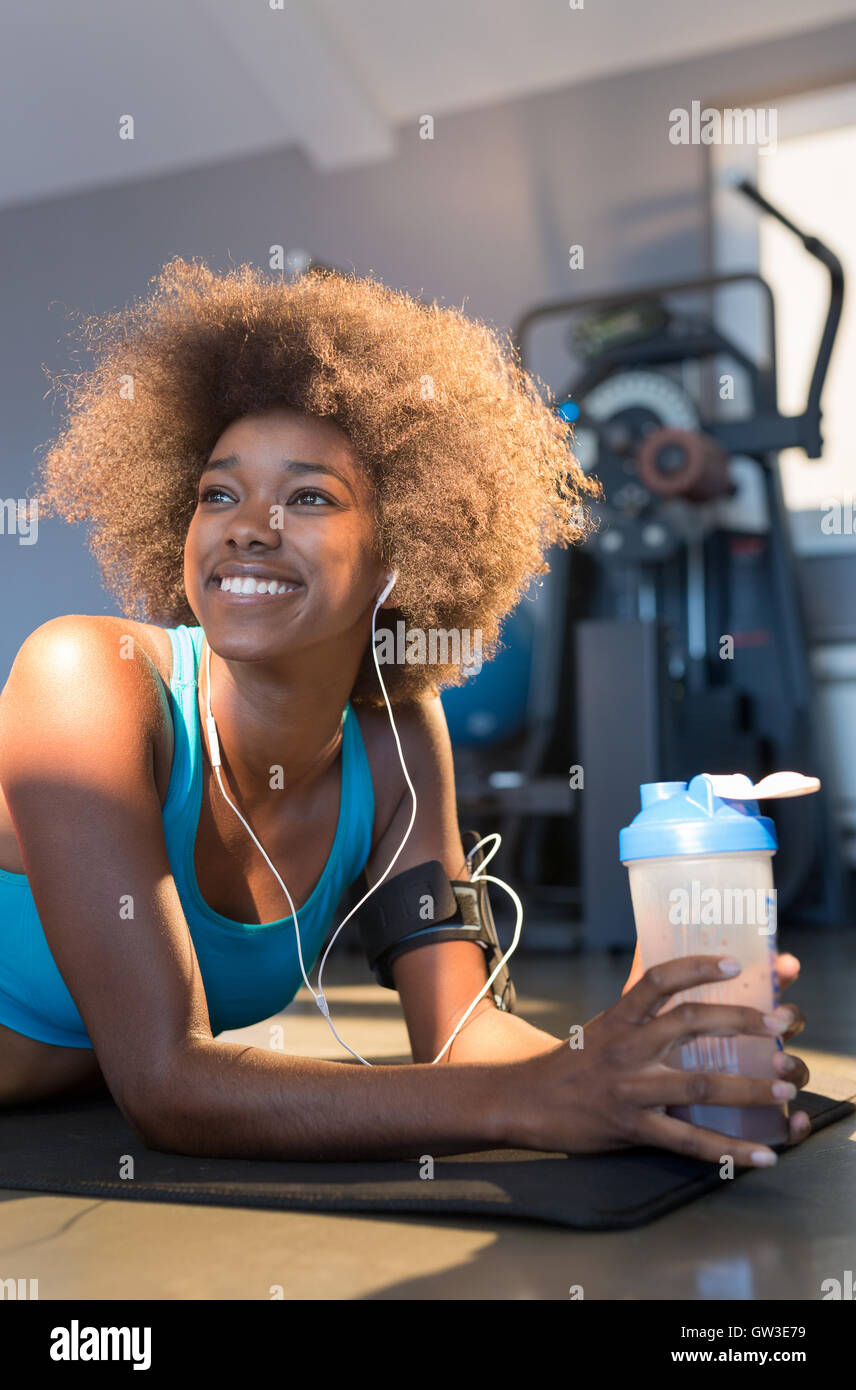 Young African American woman with a wild frizzy afro hairstyle smiling ...