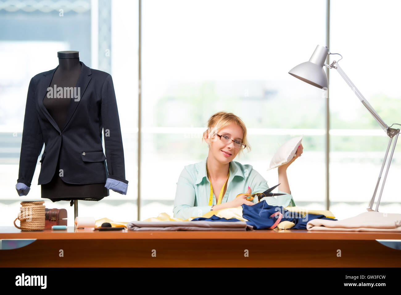 Woman tailor working on new clothing Stock Photo - Alamy