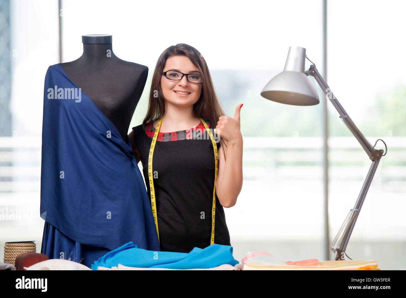 Woman tailor working on new clothing Stock Photo - Alamy