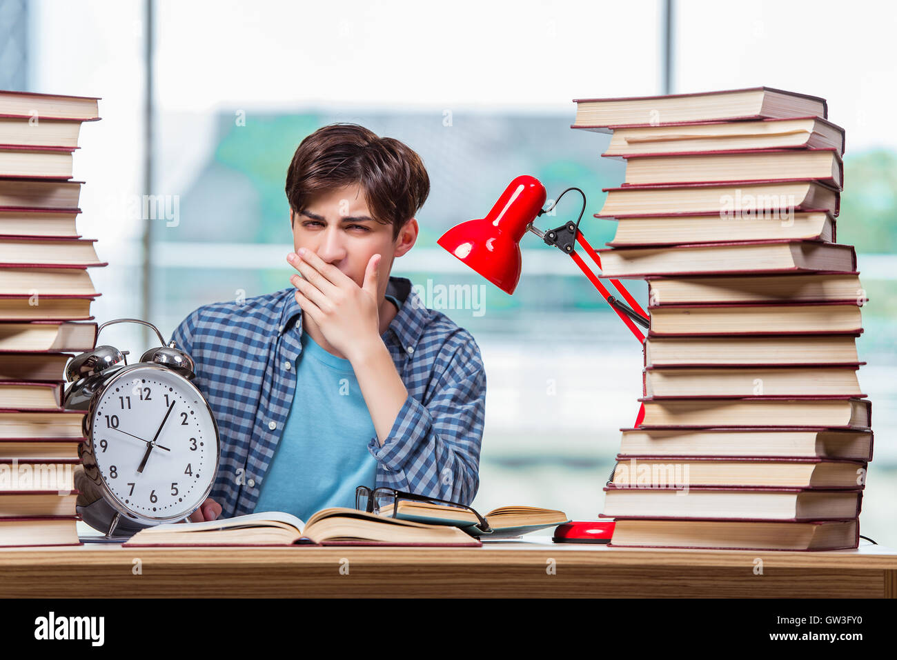 Student with lots of books preparing for exams Stock Photo - Alamy