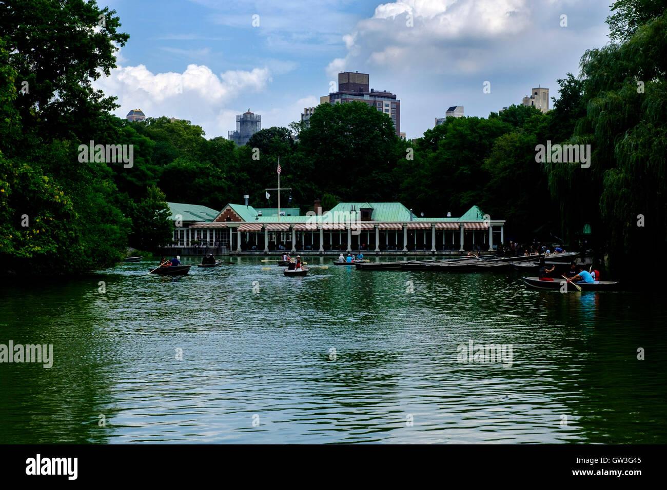 People boating on the lake in Central Park, New York in front of the ...