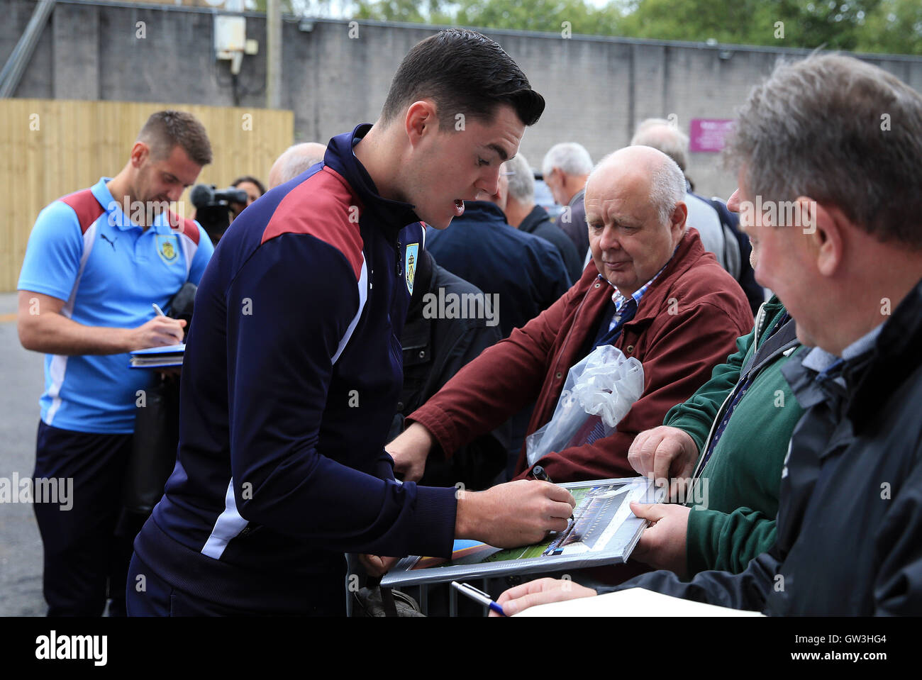 Burnley's Michael Keane signs autographs for fans during the Premier ...