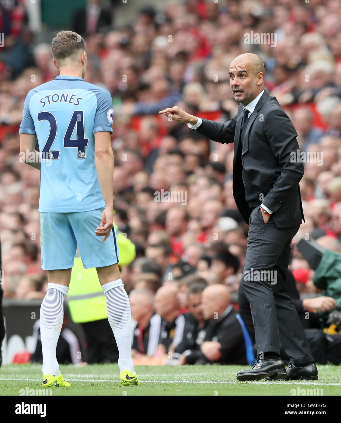 Manchester City's John Stones (left) receives instructions from manager ...