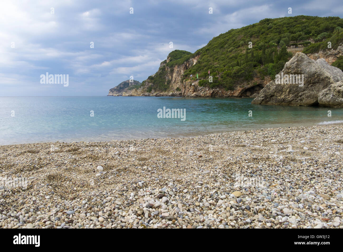 The pebble beach and cliffs at Liapades beach on the Greek island of ...
