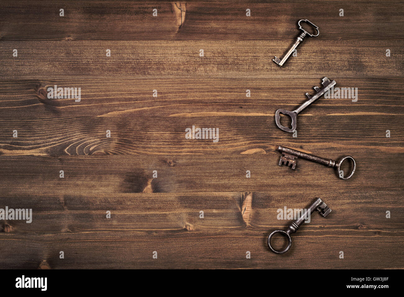Old keys from right side of wooden background Stock Photo - Alamy