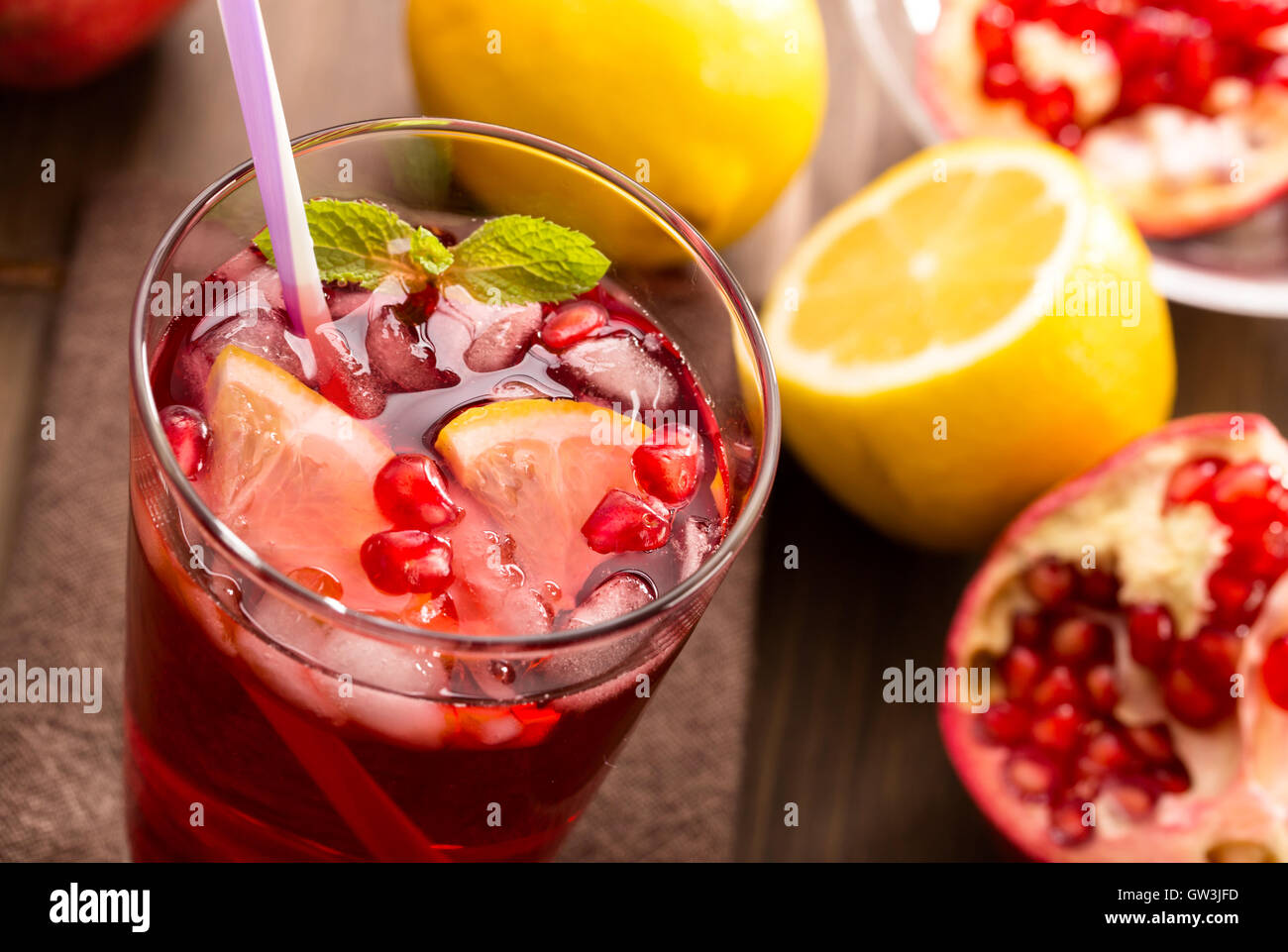 Pomegranate with lemon and ice top view Stock Photo - Alamy