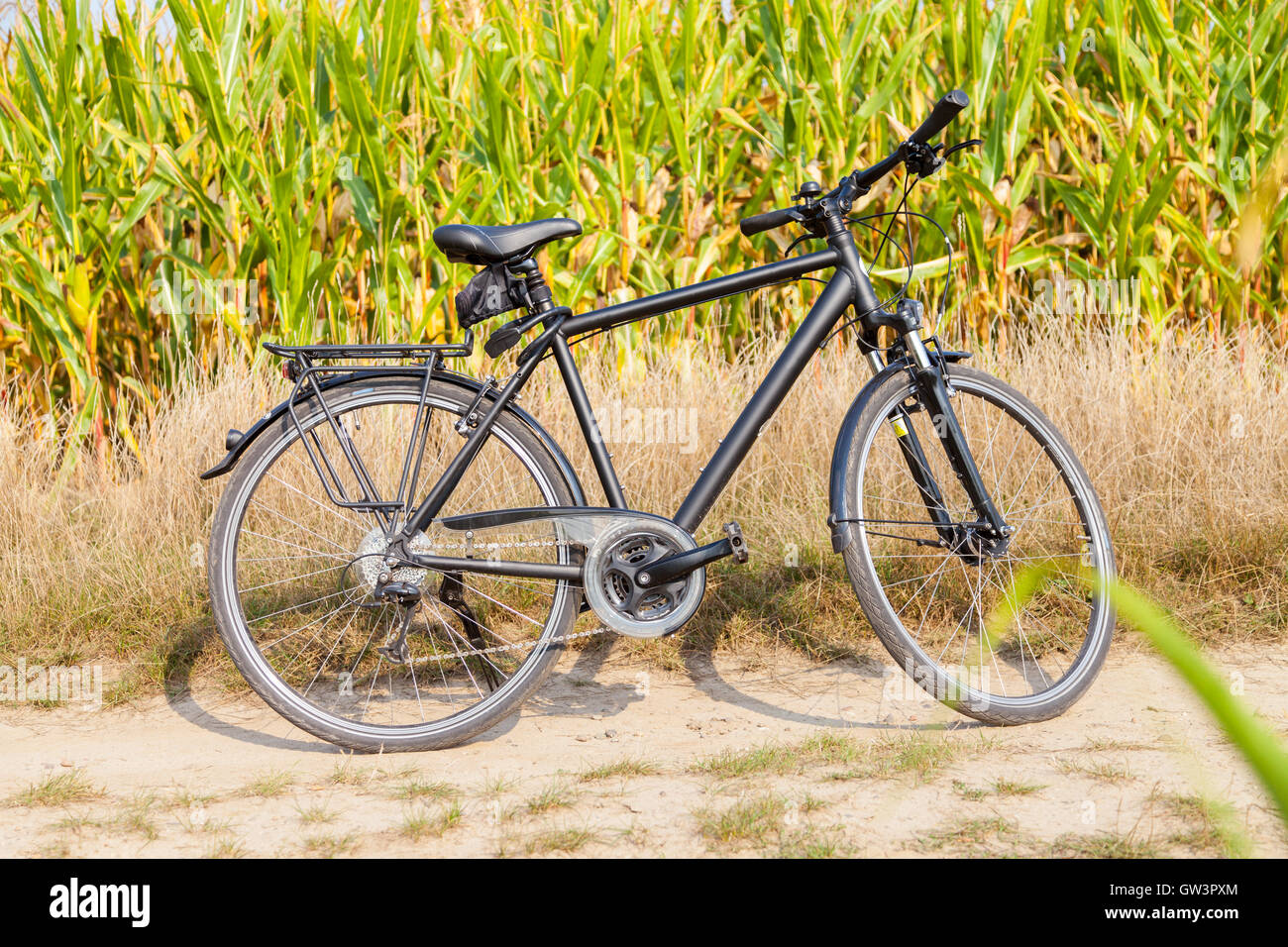 one black bike on a corn field Stock Photo - Alamy