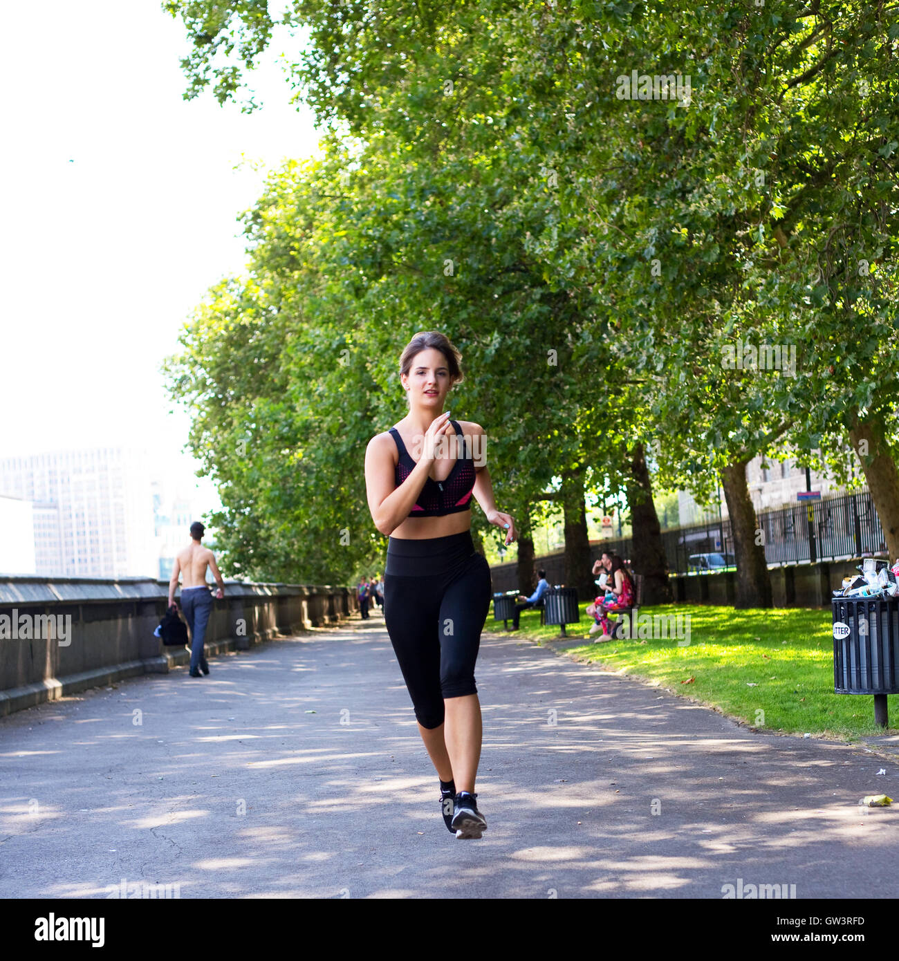 young woman running along the river Stock Photo - Alamy