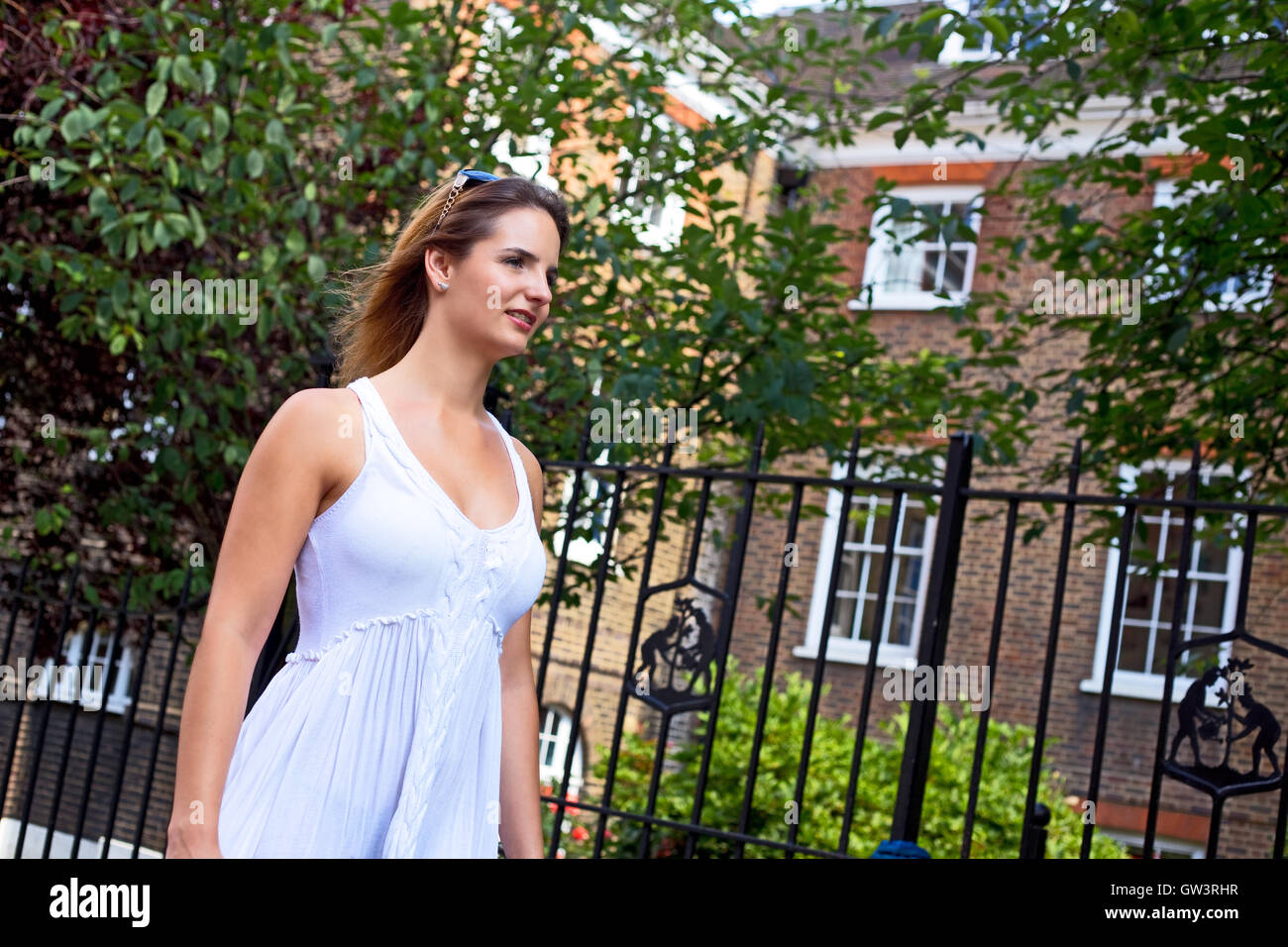 young woman walking in the street wearing a summer's dress Stock Photo ...