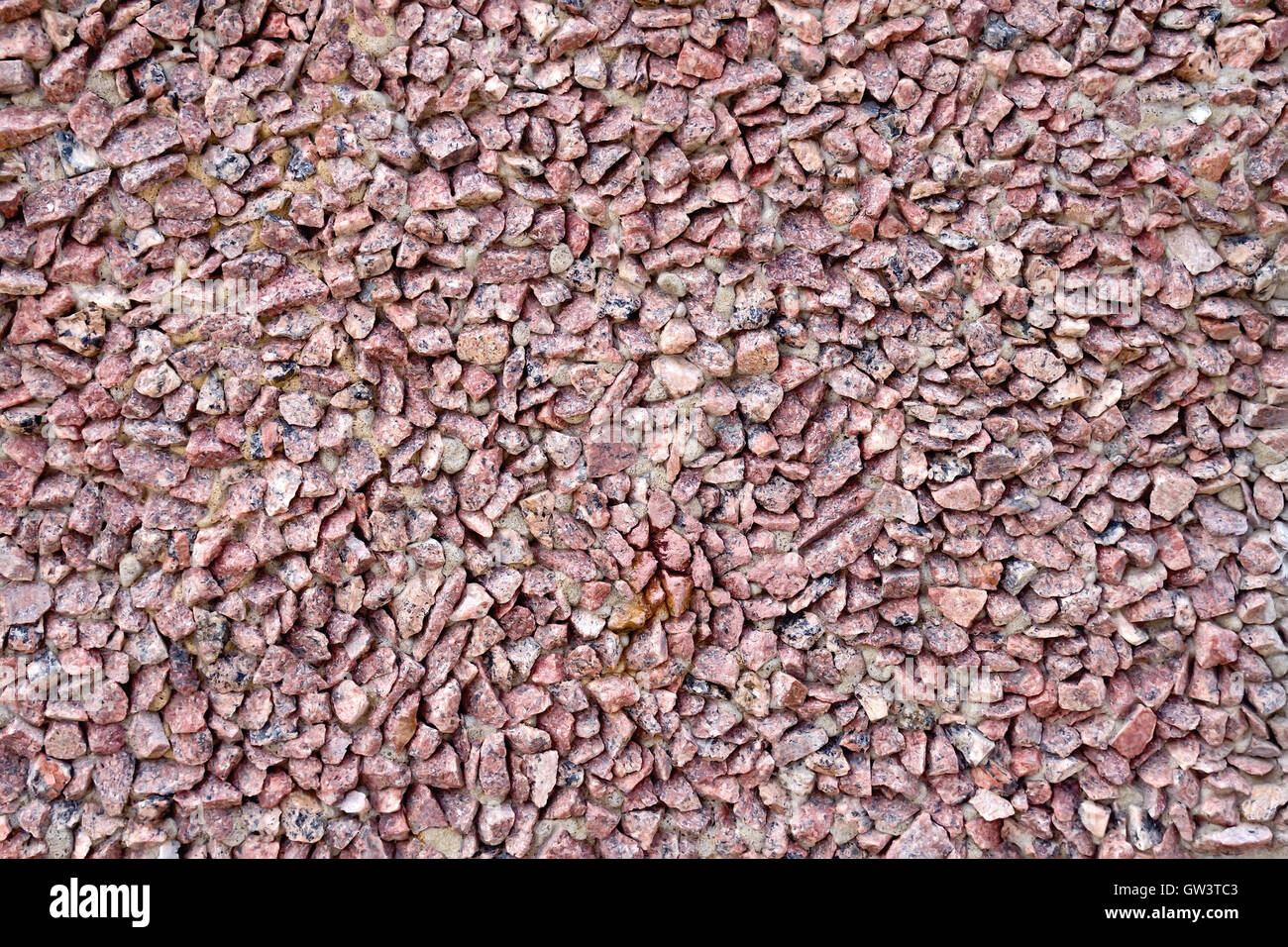 Wall of red granite gravel Stock Photo - Alamy