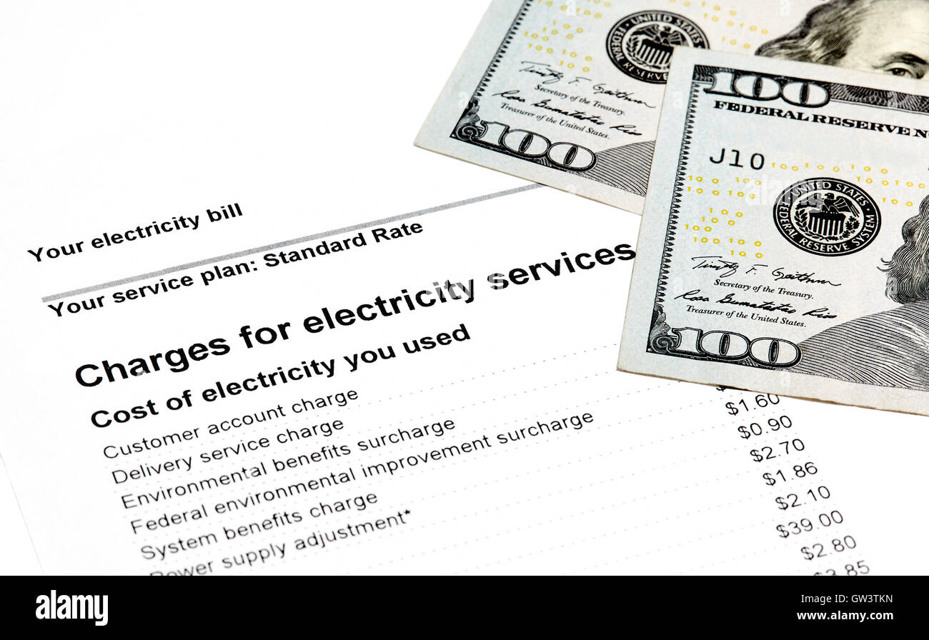 Charges for electricity services on a statement with US Currency Stock ...