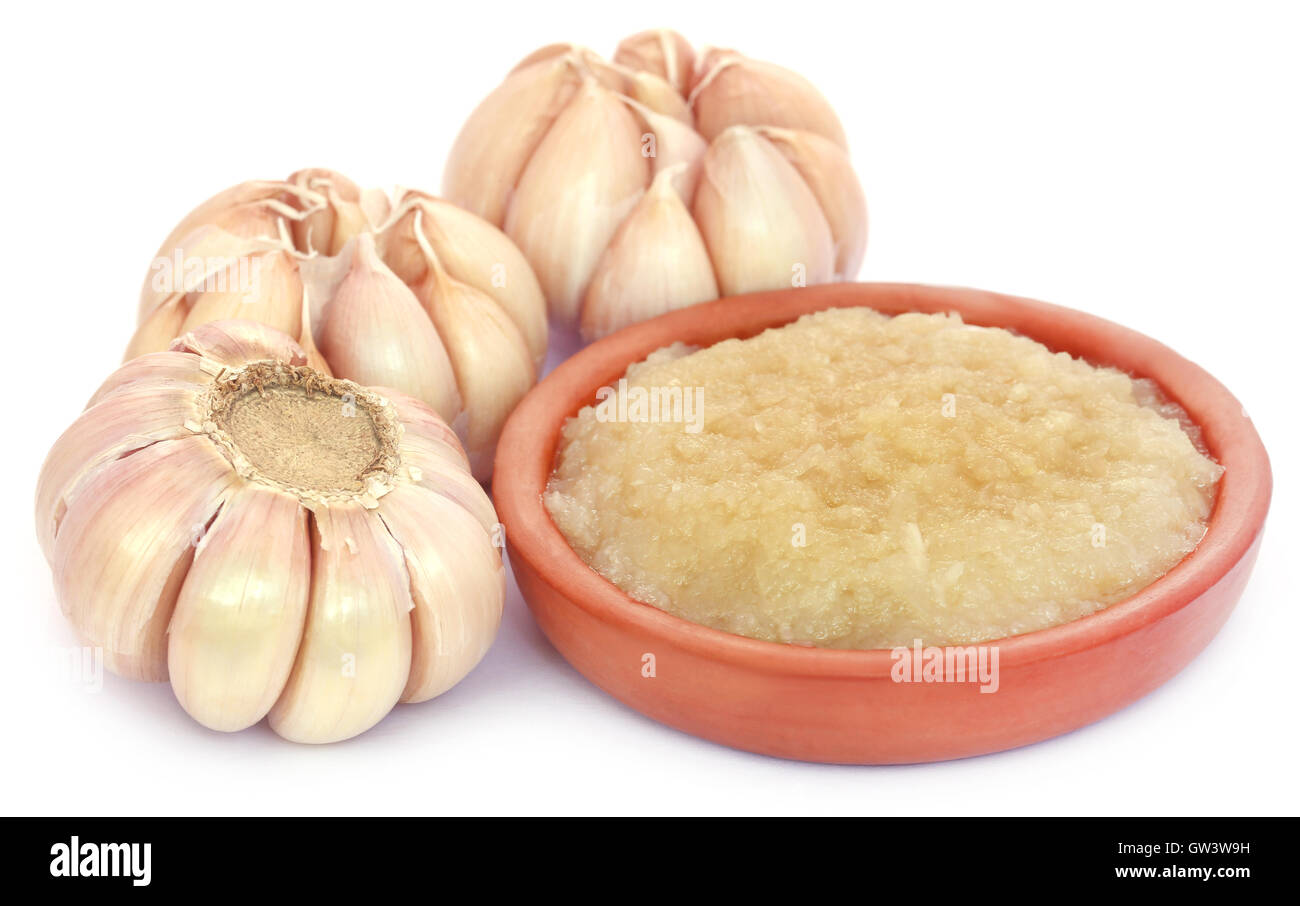 Crushed garlic with whole ones over white background Stock Photo - Alamy