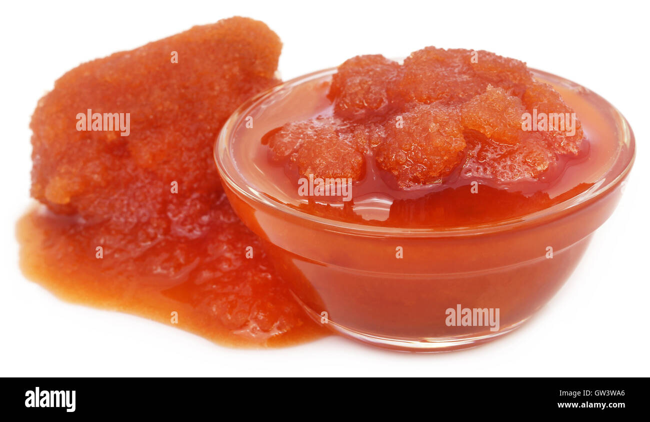 Can molasses in a glass bowl over white background Stock Photo - Alamy