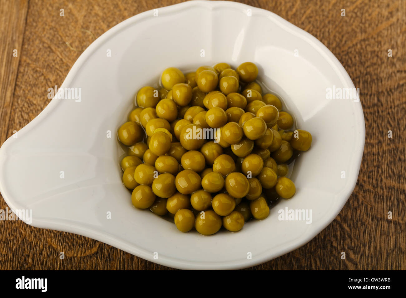 Pickled green pea on the wood background Stock Photo - Alamy