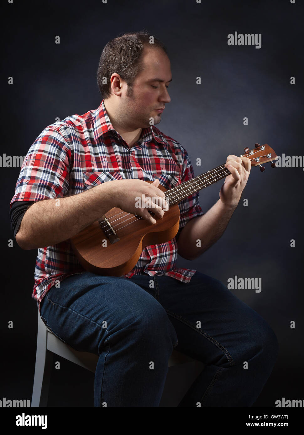portrait of musician with ukulele , studio shot Stock Photo - Alamy
