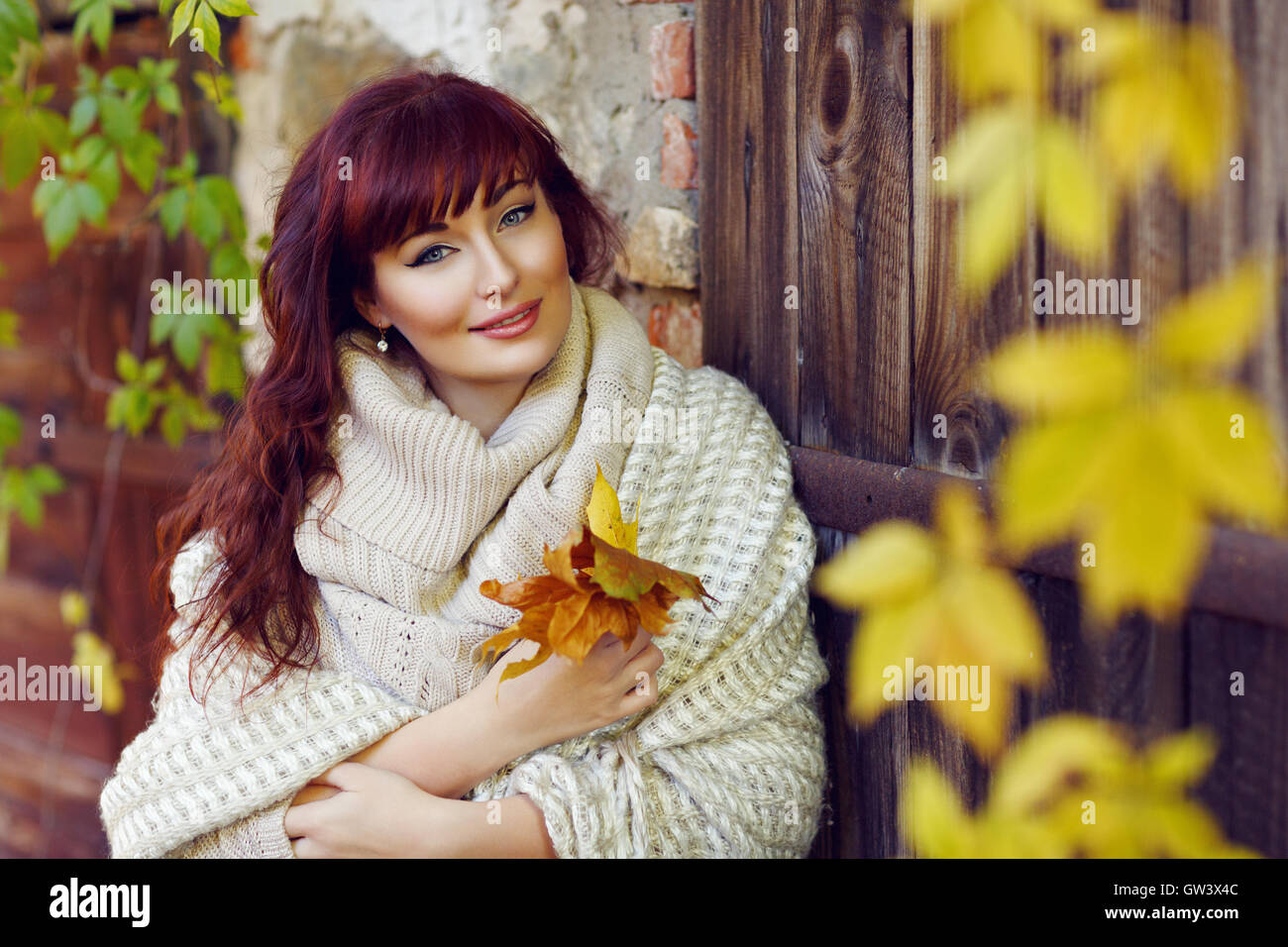 Beautiful girl outdoors with autumn leaves Stock Photo - Alamy